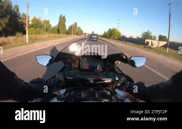 Point of view of a motorcycle rider rides in country road with traffic ...