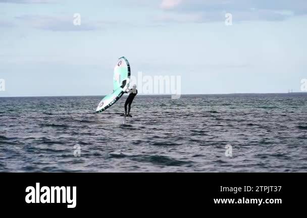 Modern water sport. Hydrofoil ride on the ocean using the wing and the ...