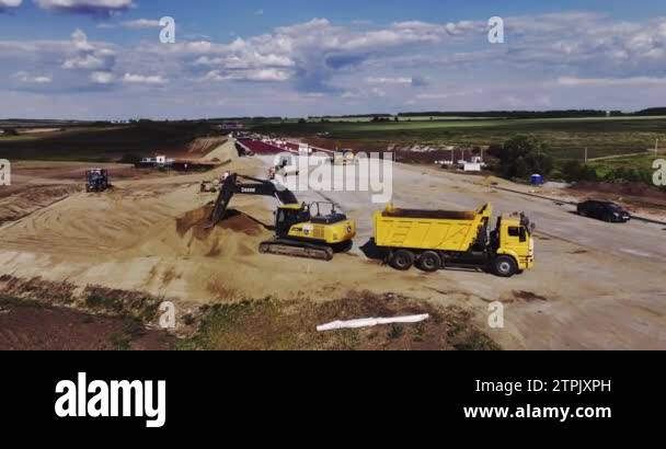 ALMATY, KAZAKHSTAN - AUGUST 16 2023: Excavator scoops up sand with ...