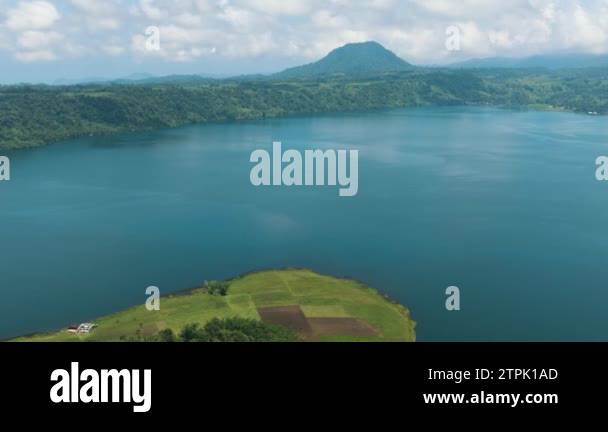 Lake Dapao in Lanao del Sur. Mountain with farmland under blue sky and ...