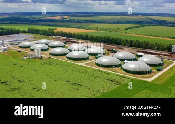 Biogas production in summer. Modern biogas plant on green fields ...