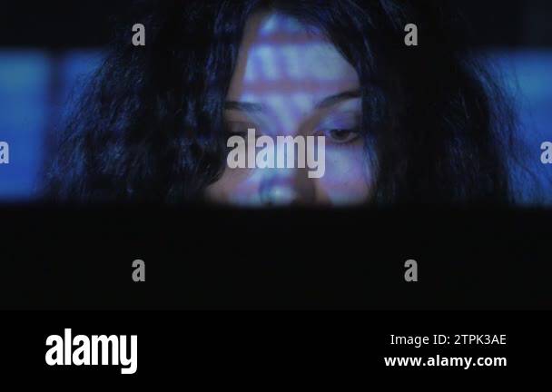 Woman Hacker programmer with curly hair is working on computer in cyber ...