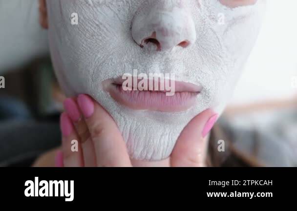 lay mask on a womans face. Close-up lips and chin. Woman touching the ...