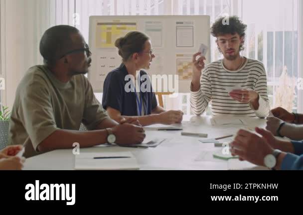 Young male student using word cards while studying English language ...