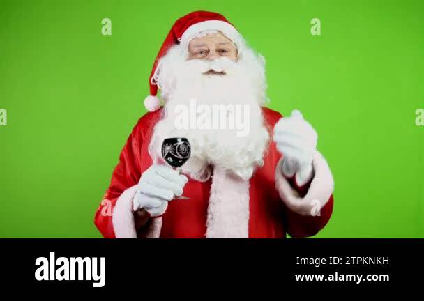 Joyful Santa Claus with glass of wine with toast congratulates on ...