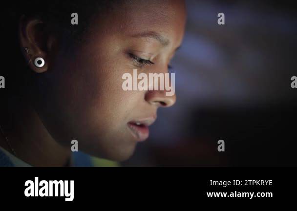 Side close-up face beautiful young American black woman looking at ...