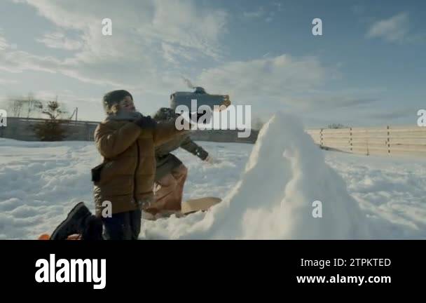 Full handheld shot of young children playing outdoors with friends on ...