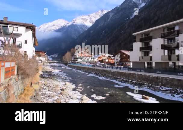 Beautiful view of a frozen river flowing through the Otztal Valley in ...