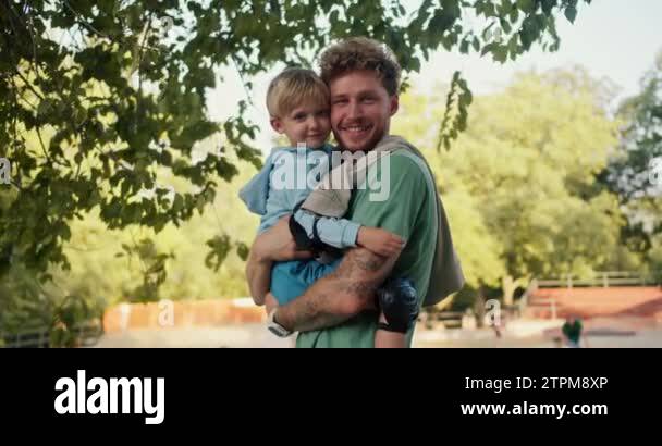 Happy dad with curly hair and Green T-shirt together with his little ...