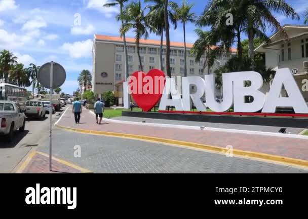 Big white capital letters I love Aruba along a road in the center of ...