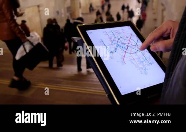 Man in underground examines the subway map using the tablet Stock Video ...