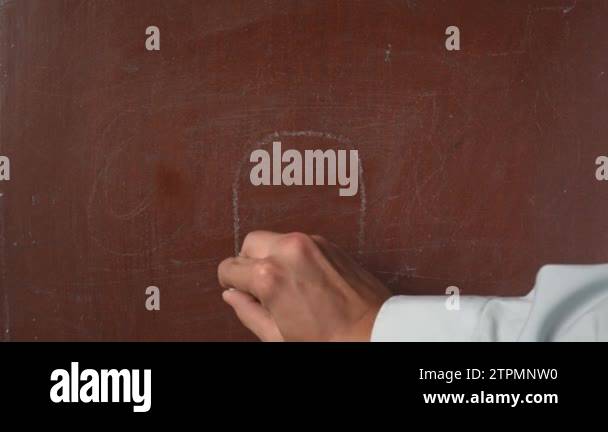 Textured chalkboard background. Male hand drawing an abstract human ...