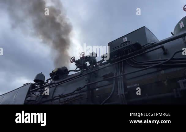 Operating steam locomotive on railway station. Retro steam train ...