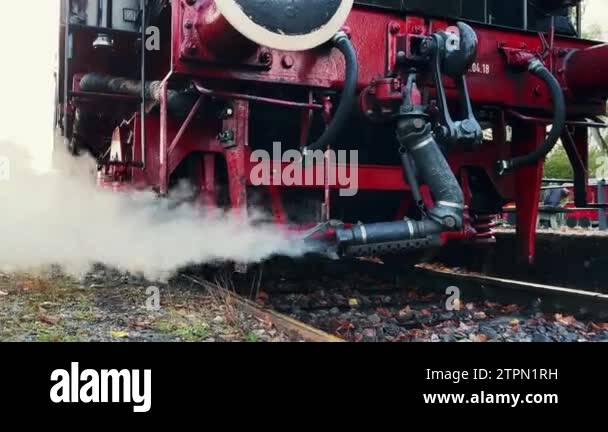 Pipe of old historic German locomotive releases thick clouds of steam ...