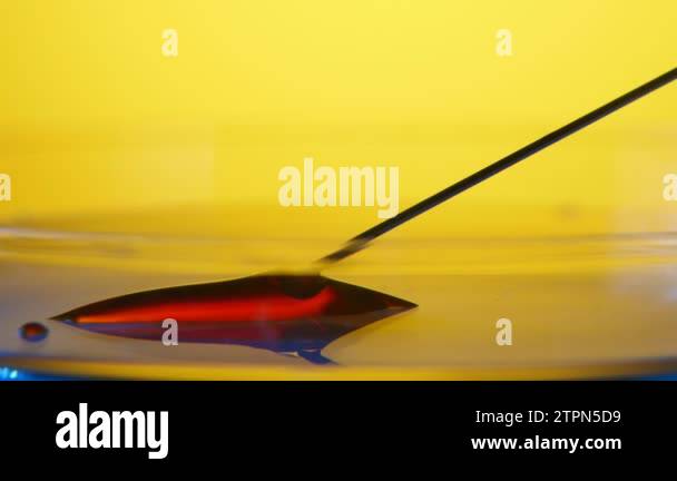 Thin needle takes in red blood from a glassy area in a medical ...