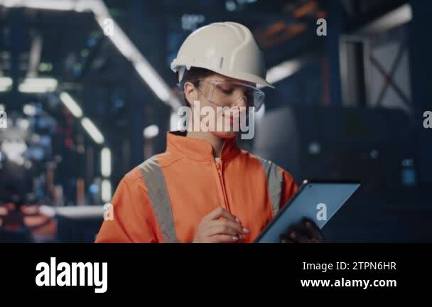 Woman engineer holding tablet cheking production indicators modern ...