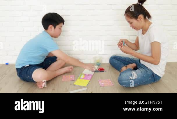 Asian child learning to folding Japanese paper origami with mother, art ...
