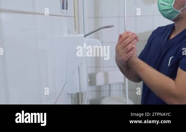 Doctor disinfects and washing his hands dry before entering the ...