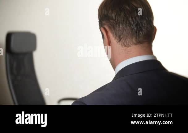 a brunette woman in a suit asks questions to a man in an interview. 4k ...