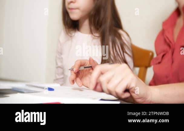 Mother and daughter working on a homework together on a laptop. online ...
