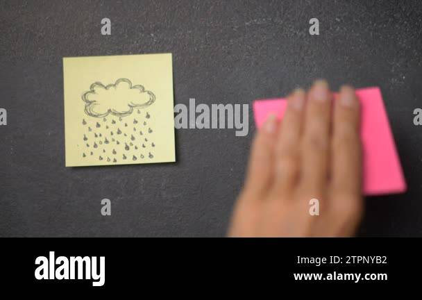 Sticky note on the blackboard / Closeup woman's hand sticking note with ...