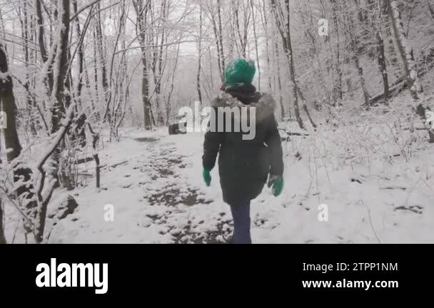 Snow-covered trees provide a fabulous backdrop for this young woman ...