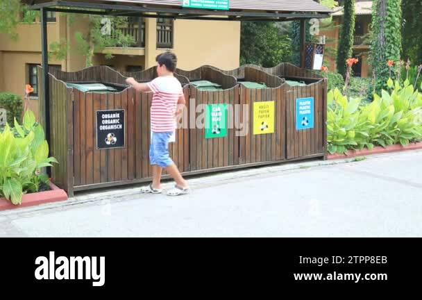 Garbage separation. Child throwing banana peel into the trash Stock ...