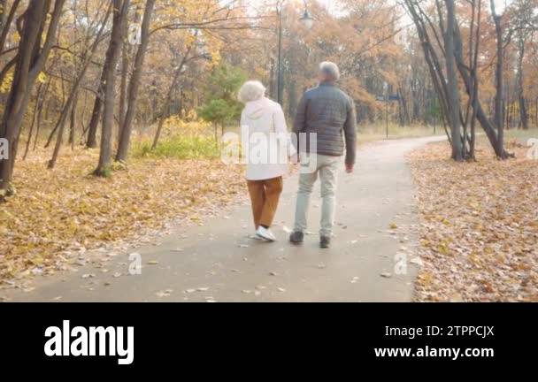 loving old people walk nature have fun in forest park. Cute senior ...