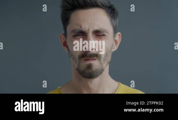 Close-up portrait of furious guy making angry face and showing teeth ...