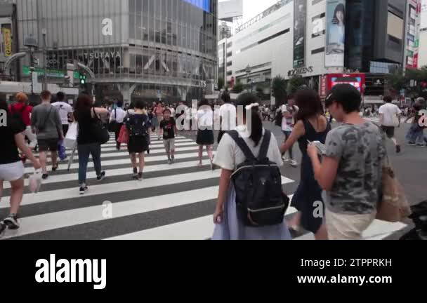 people cross the Shibuya intersection in Tokyo Stock Video Footage - Alamy