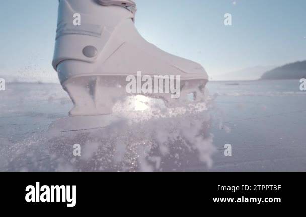 LENS FLARE, SUPER SLOW MOTION, CLOSE UP: Ice flies as lady turns on her ...