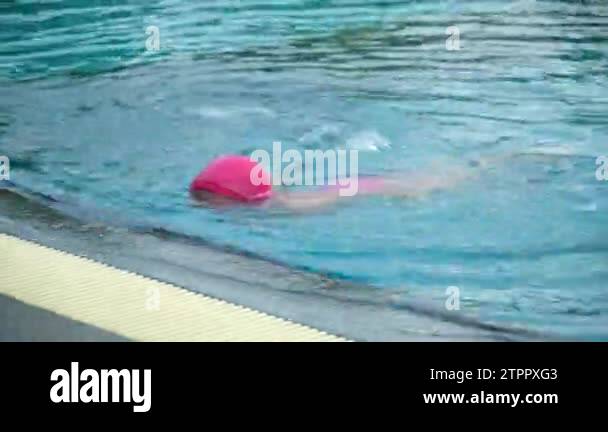 Little girl plays in the outdoor swimming pool of tropical resort ...