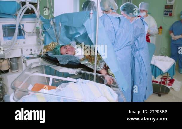 Mother Holds Newborn Baby in Hospital. Mother Holding Her Newborn Baby ...