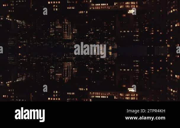Night city theme footage with lighted windows in high rise buildings ...