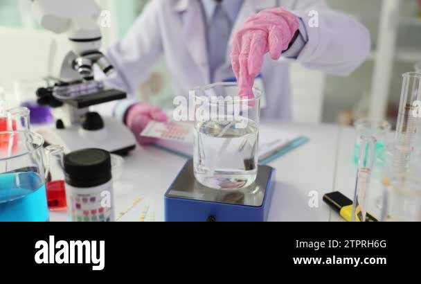 Scientist and test strip with indicators of different colors for liquid ...