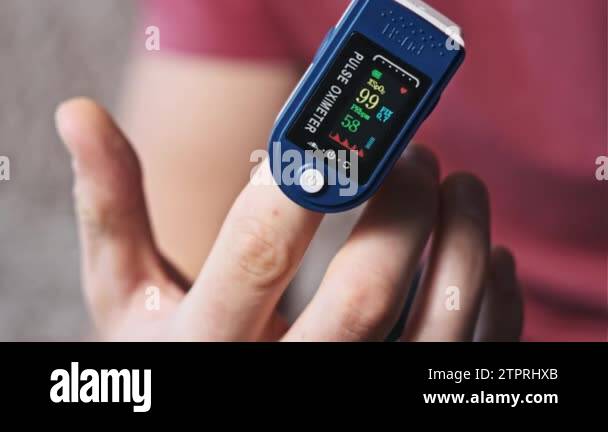 Pulse oximeter measures pulse and oxygen saturation on a male finger ...