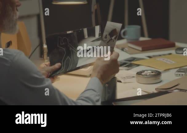 Over the shoulder of serious gray haired bearded Caucasian FBI agent ...