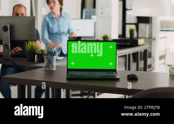 Greenscreen laptop in coworking space placed on empty office desk, open ...