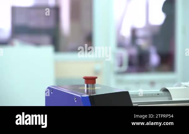 Red color button of stop. Close up/The employee presses the button and ...