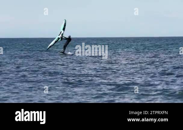 Modern water sport. Hydrofoil ride on the ocean using the wing and the ...