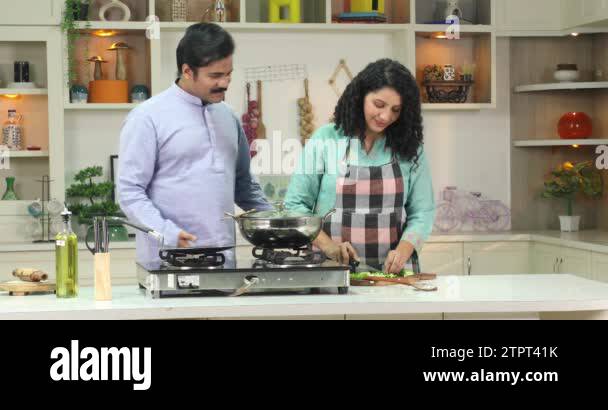 Wife cooking food and husband tasting food while cooking Stock Video ...