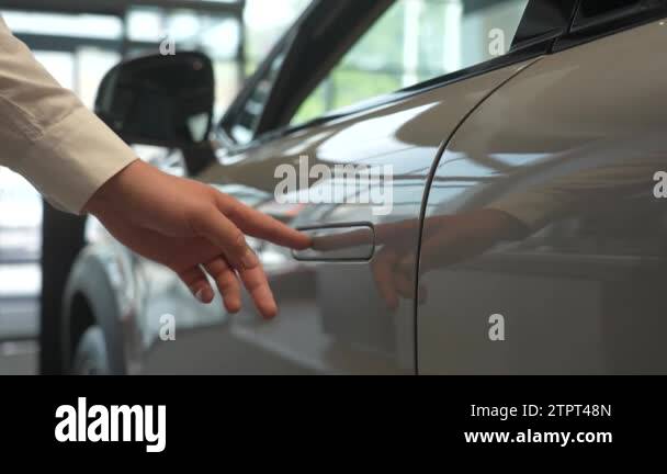 A man opens a car door with a fingerprint. Integrated handle Stock ...