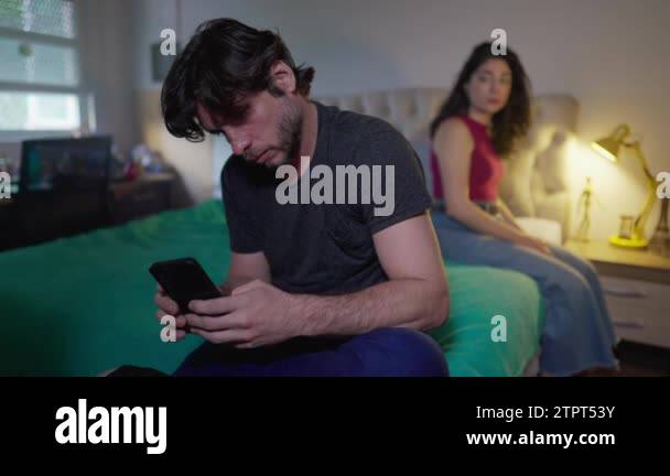 Disconnected couple: Boyfriend looking at phone ignoring girlfriend by ...