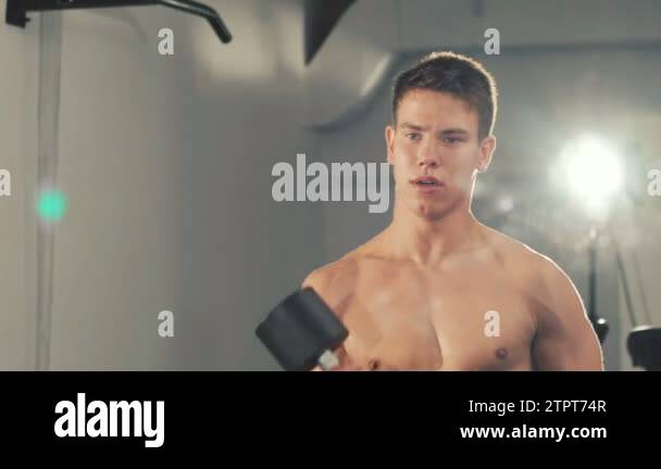Bodybuilder training with the loads for arms muscles in gym Stock Video ...