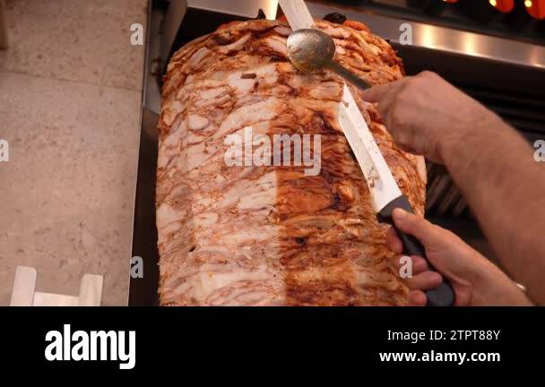 Meat on spit for Shawarma. Grilled meat. Cooking. Chef's Knife Cut ...
