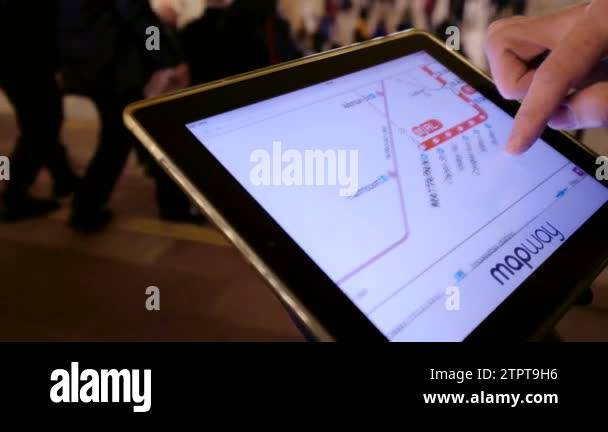 Man in underground examines the subway map using the tablet Stock Video ...