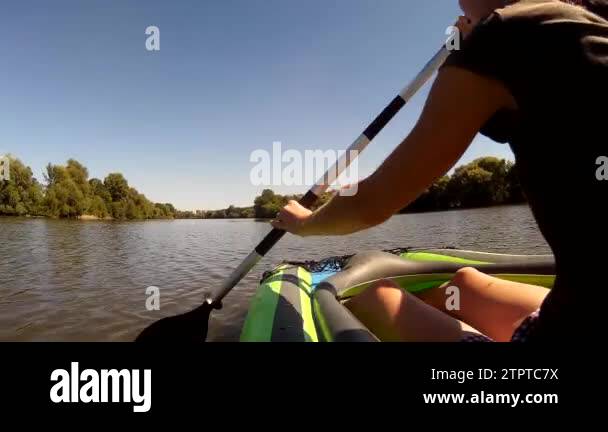 Young girl rowing in a kayak. Ukraine, Southern Bug river. Side view Stock Video Footage - Alamy