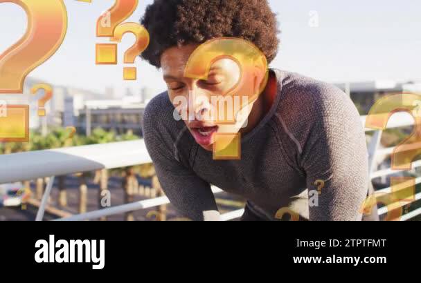 Animation of question mark symbols over tired biracial athlete standing ...