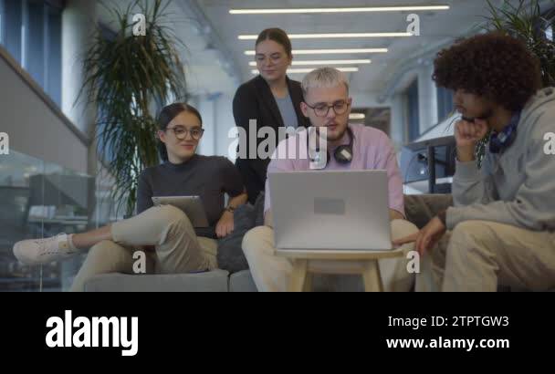 A diverse group of colleagues exchange business experiences, engage in ...