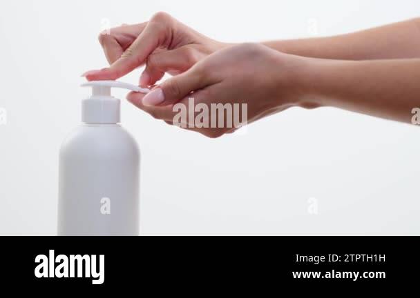 Graceful female hands delicately apply moisturizing cream, gently ...